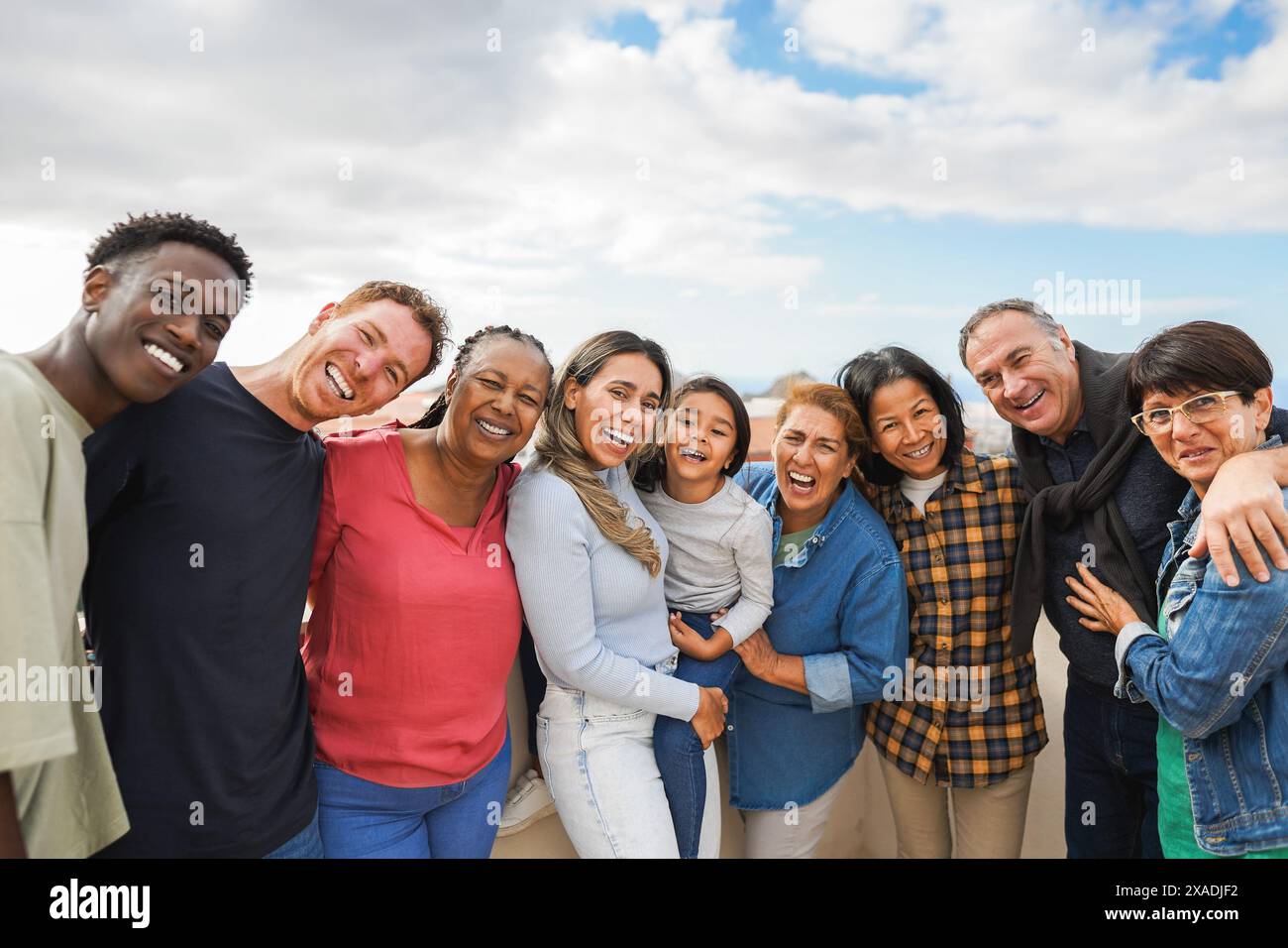 Group of multigenerational friends smiling in front of camera - Multiracial friends of different ...