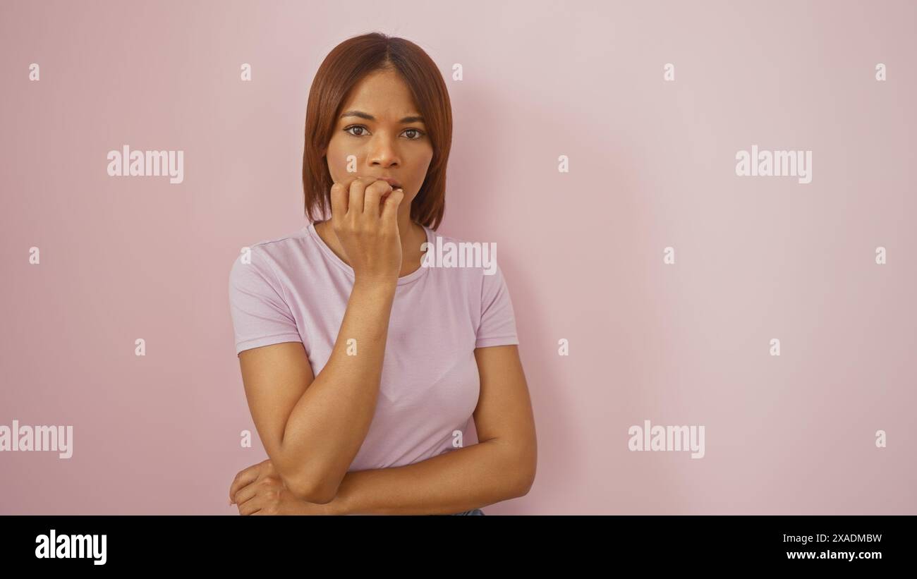 Thoughtful african american woman in a casual outfit poses against a ...