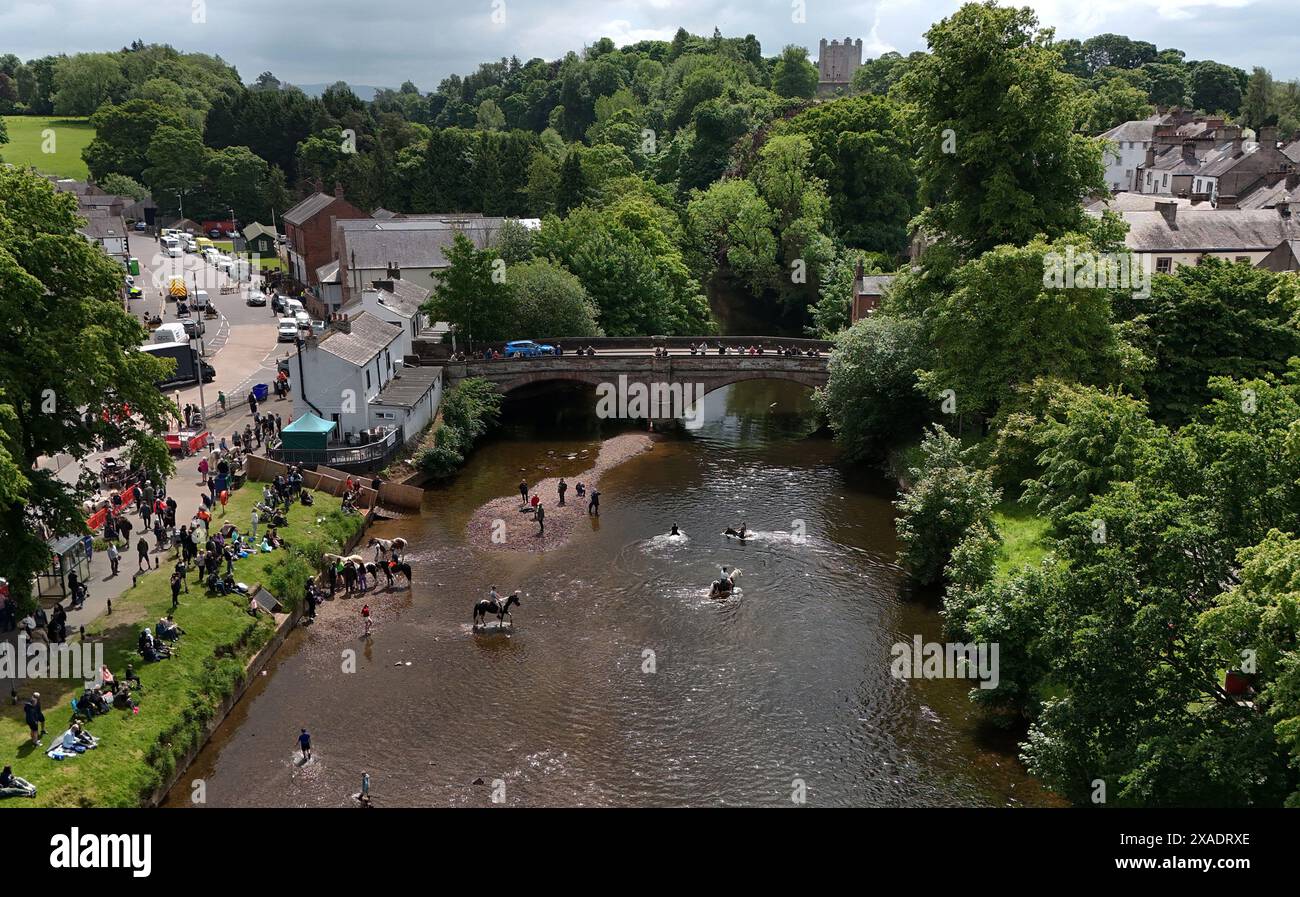 People and horses in the river at the Appleby Horse Fair, the annual ...