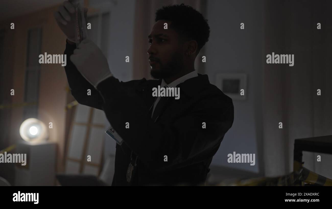 African american detective analyzes evidence at crime scene indoors ...