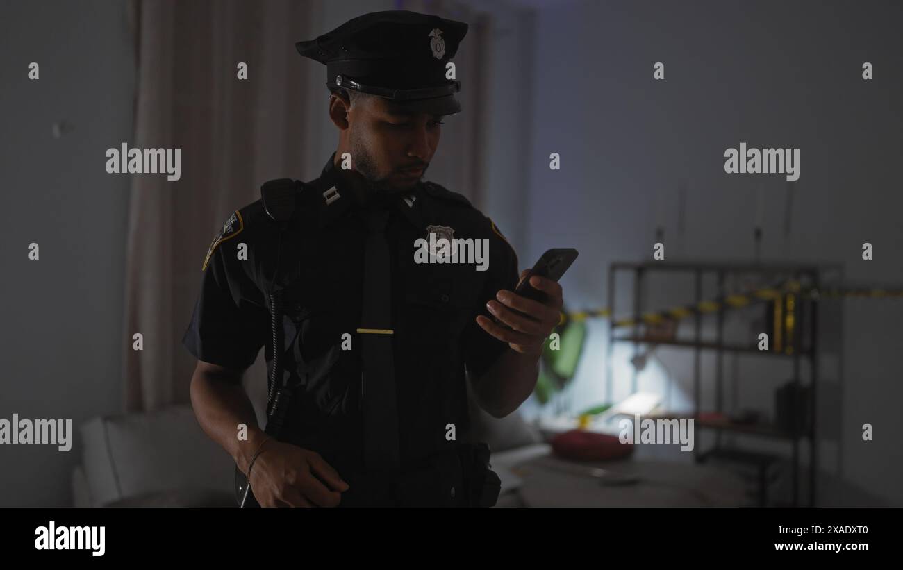 African american police officer indoors examining smartphone with crime ...