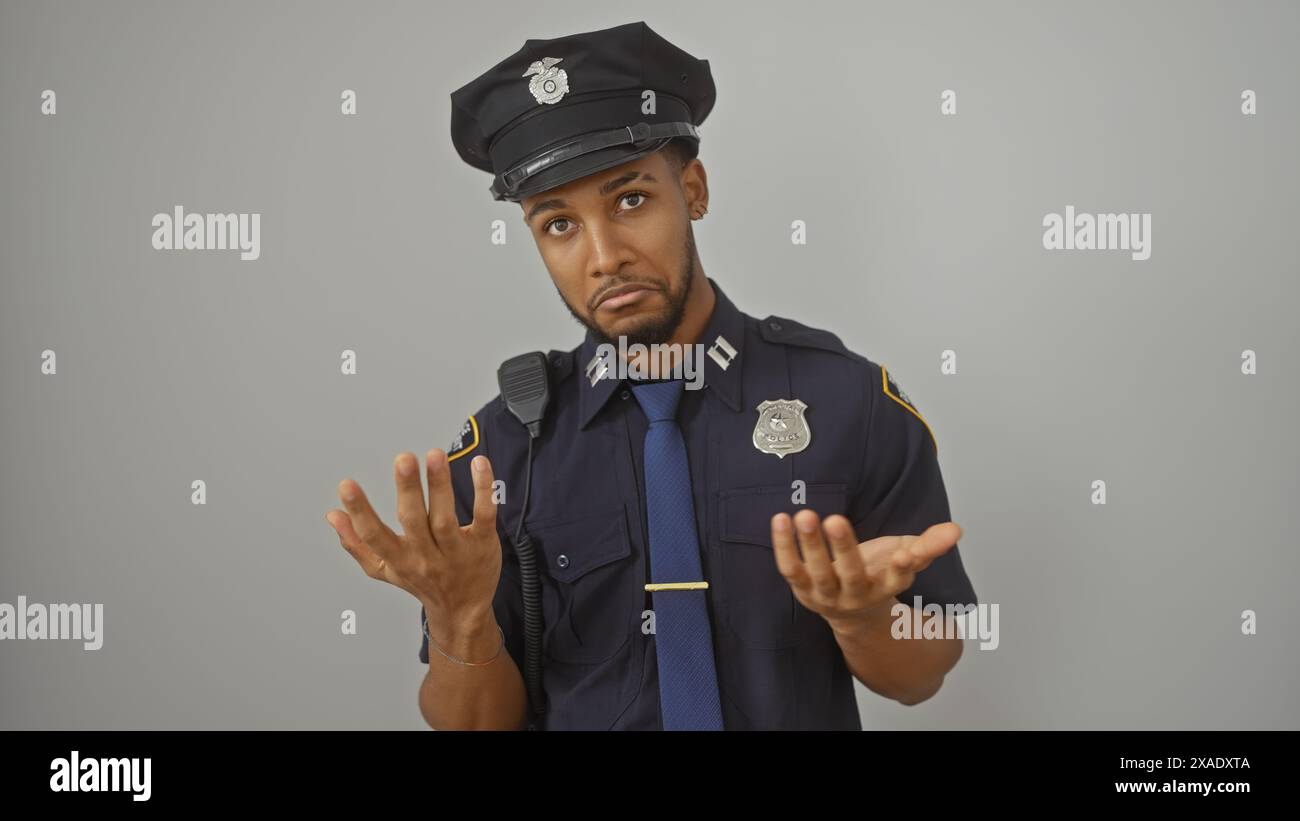 A confused african american police officer on a white background ...
