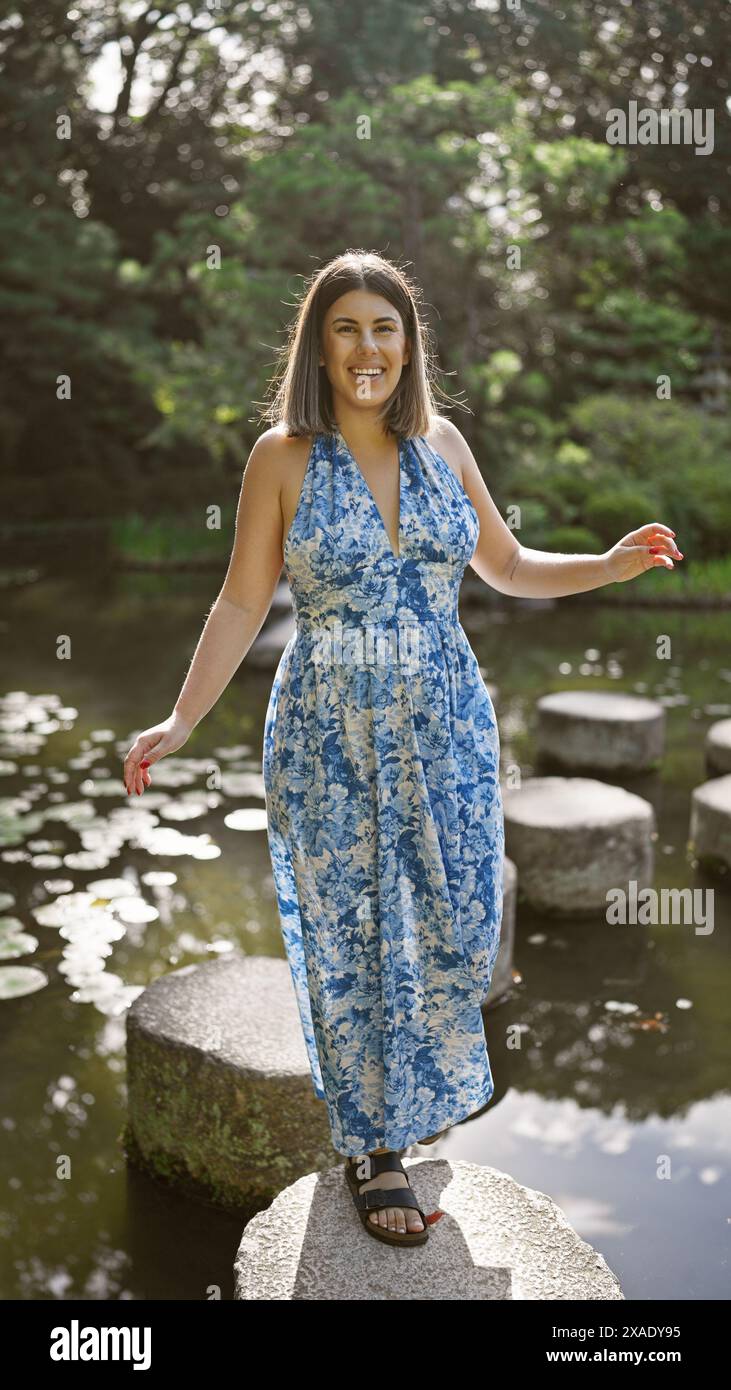 Beautiful hispanic woman's leisurely summer walk along stone path ...