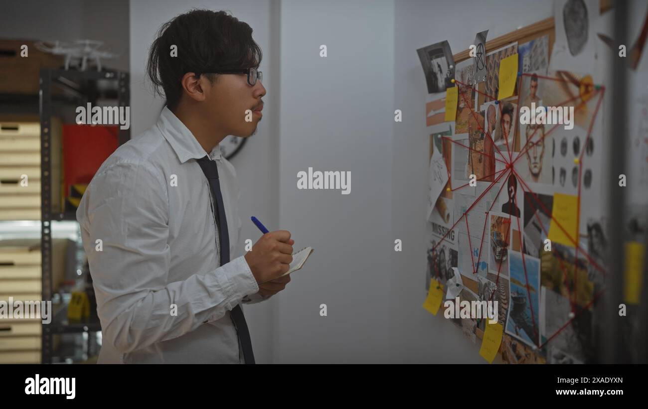 Asian man analyzing evidence board in detective office setting Stock ...