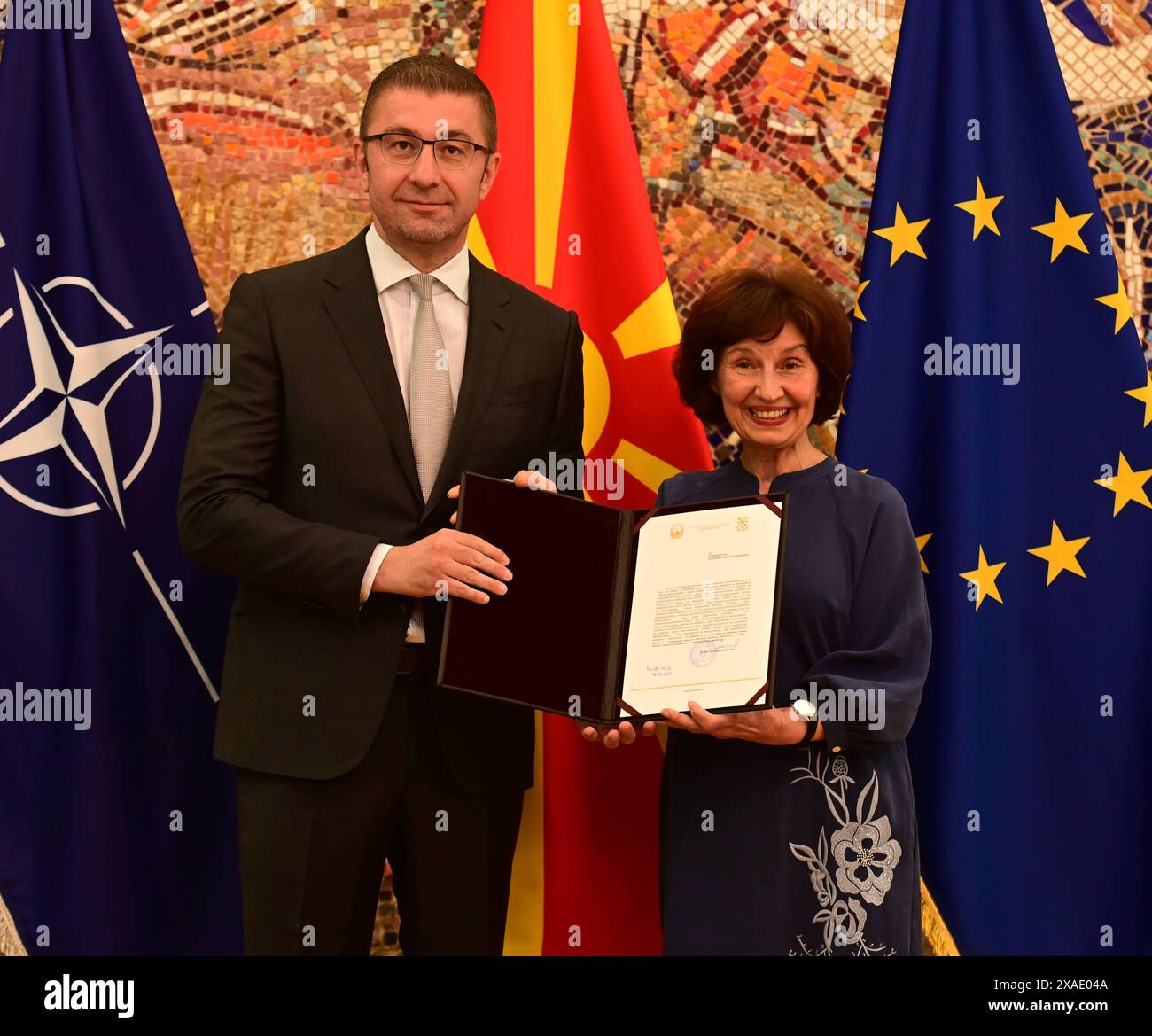 North Macedonia s President Gordana Siljanovska Davkova R hands over ...