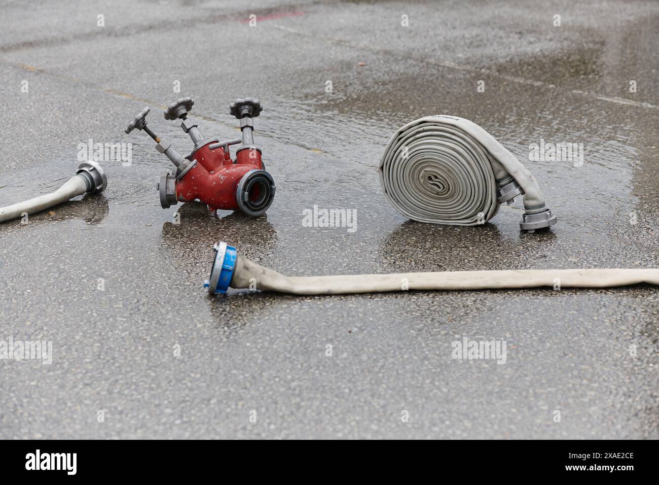 Coiled Fire Hose Ready for Action on the Ground Stock Photo - Alamy