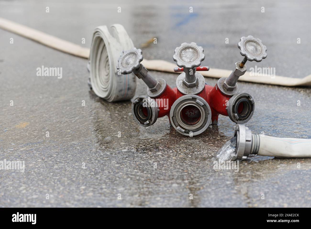Coiled Fire Hose Ready for Action on the Ground Stock Photo - Alamy