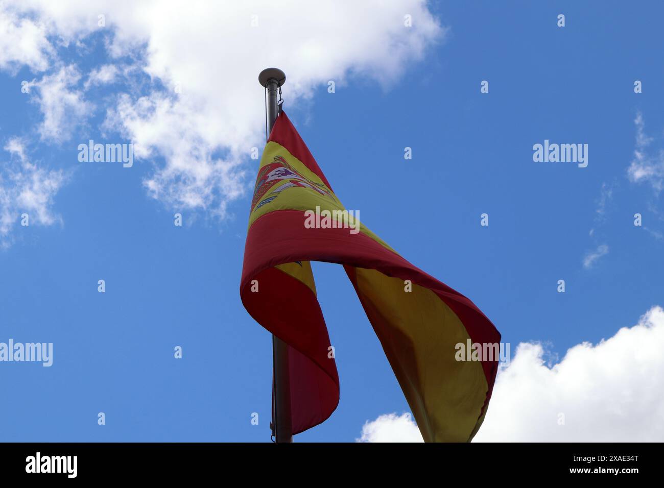 Spanish flag in the cloudy sky. waving in the sky Stock Photo - Alamy