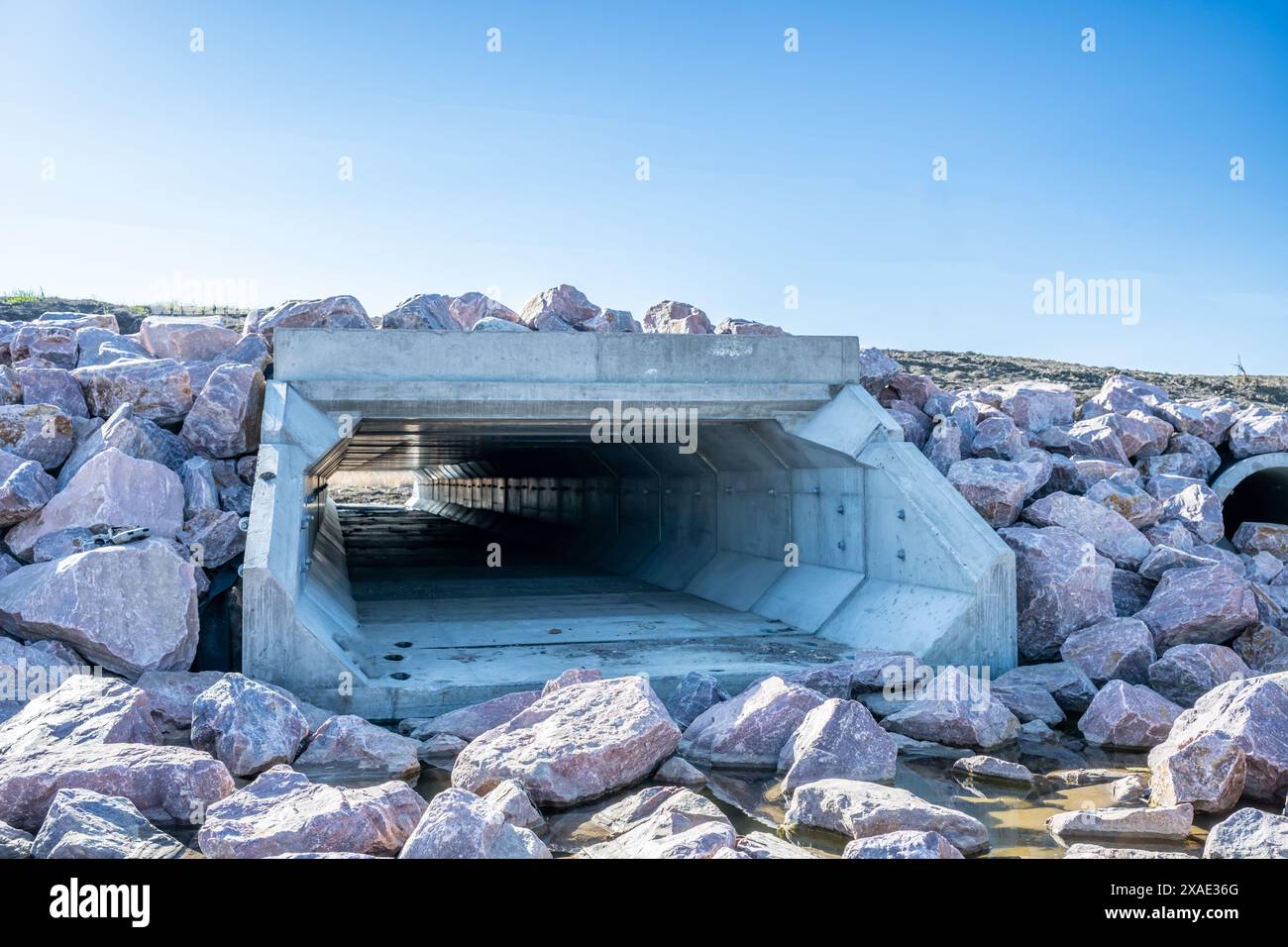 Concrete culvert Tunnel Amidst Rock Pile under a road Stock Photo - Alamy
