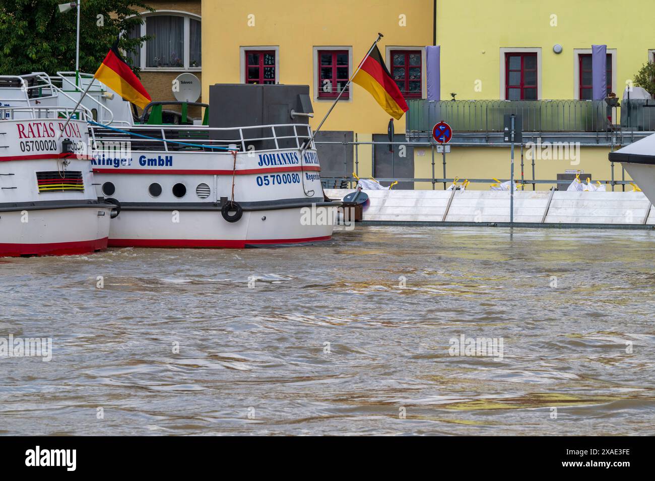 06 June 2024, Bavaria, Regensburg: Ships lie on the banks of the Danube ...