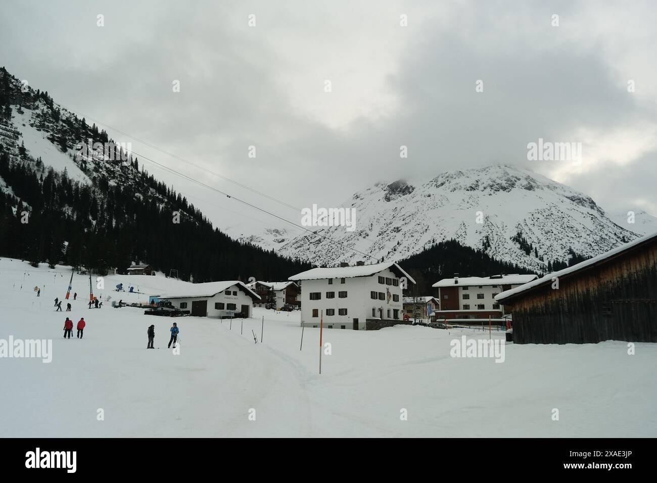 A snowy mountain range with a small town in the distance. The town is ...