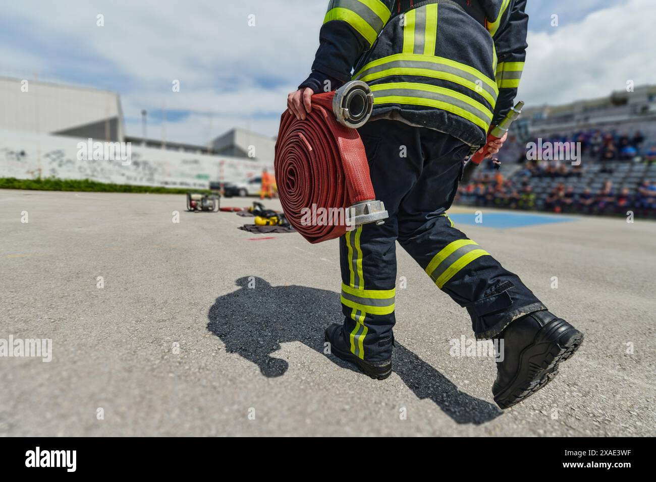 In a dynamic display of synchronized teamwork, firefighters hustle to ...
