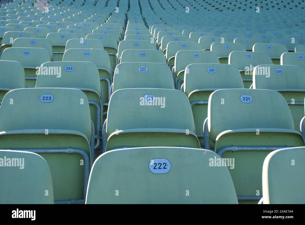 A row of empty seats in a stadium with numbers on them. The seats are ...