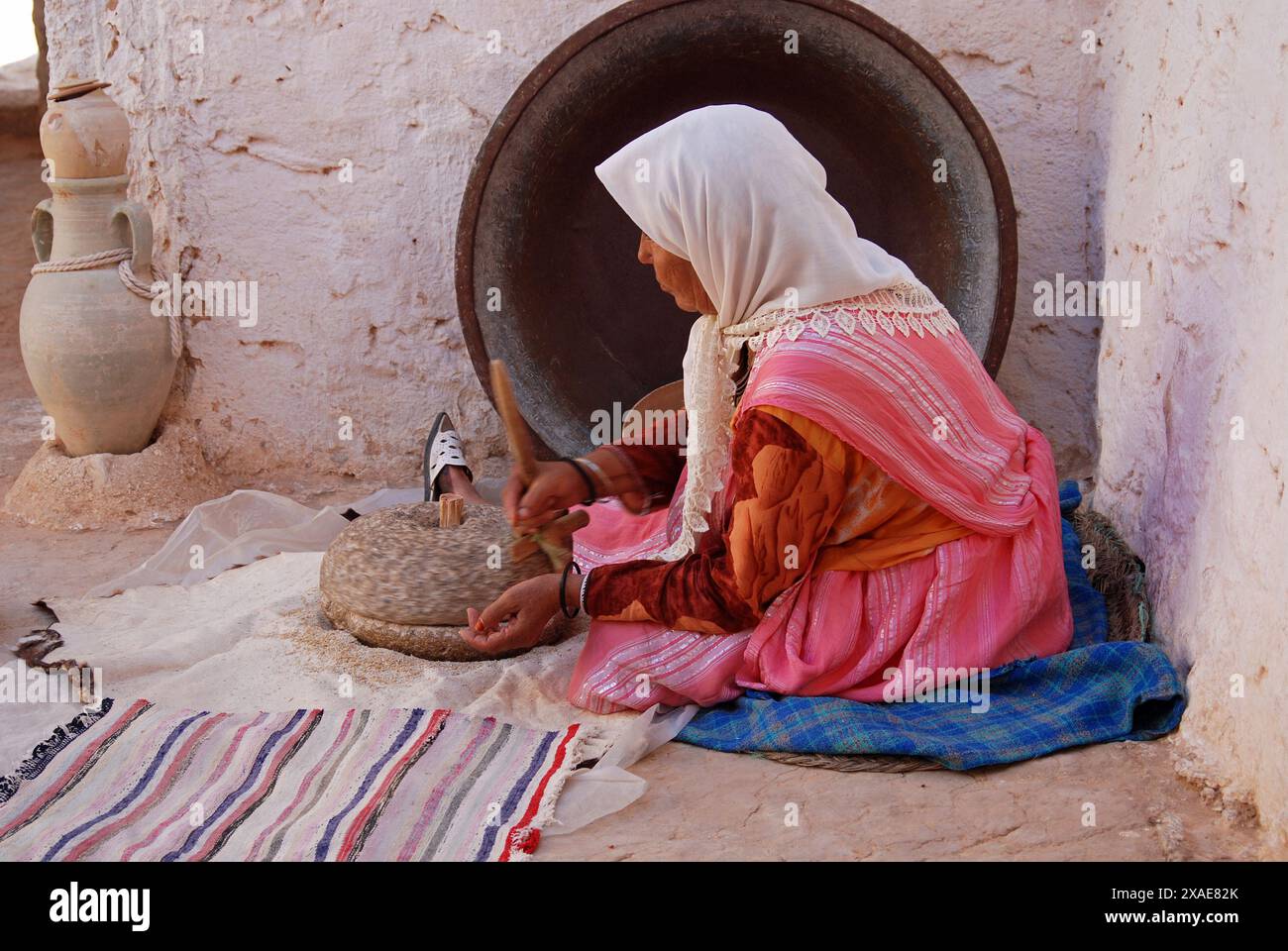 Berber Woman in Troglodyte House Grinding Corn, Matmata, Gabes ...