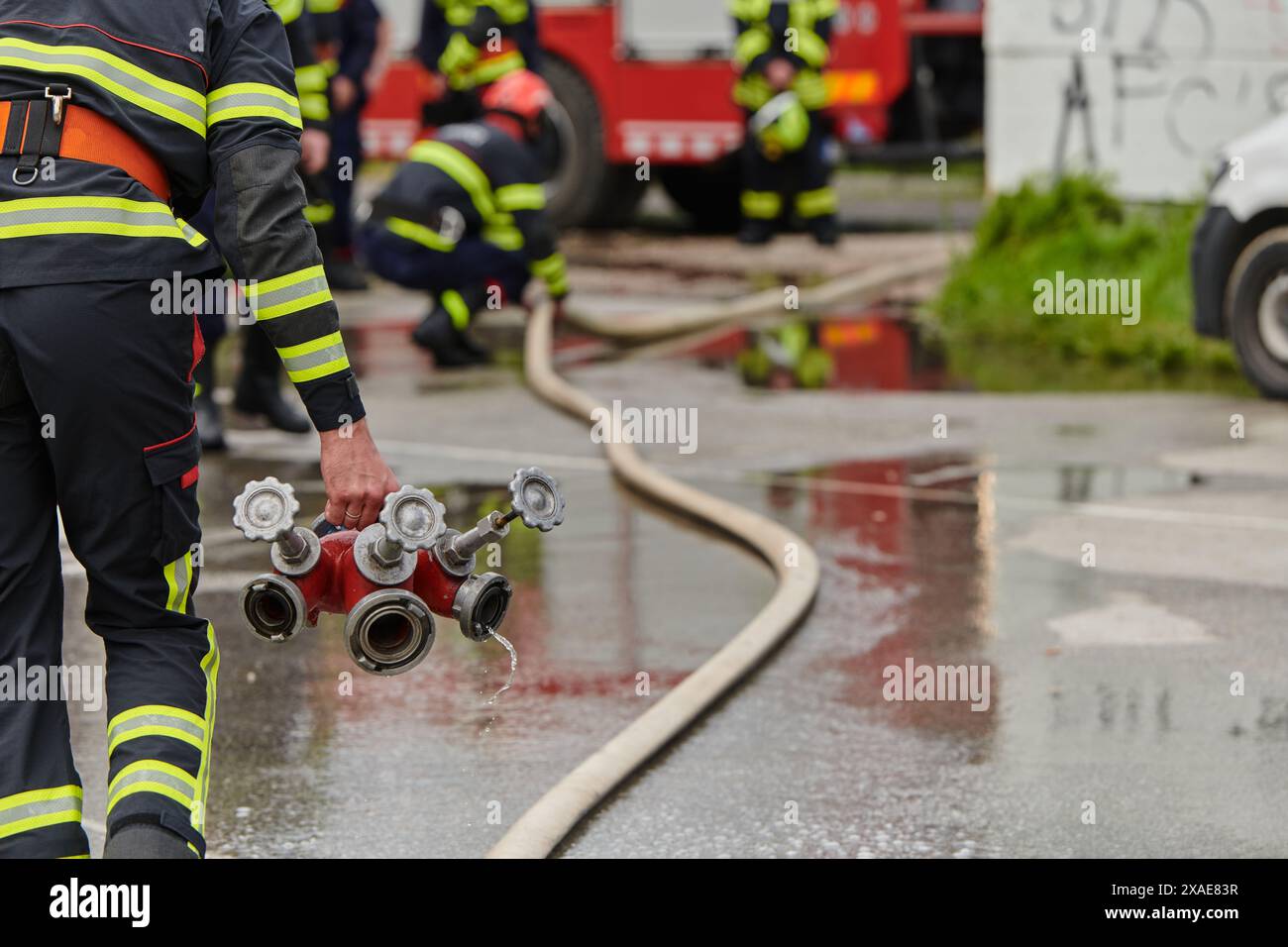 In a dynamic display of synchronized teamwork, firefighters hustle to ...