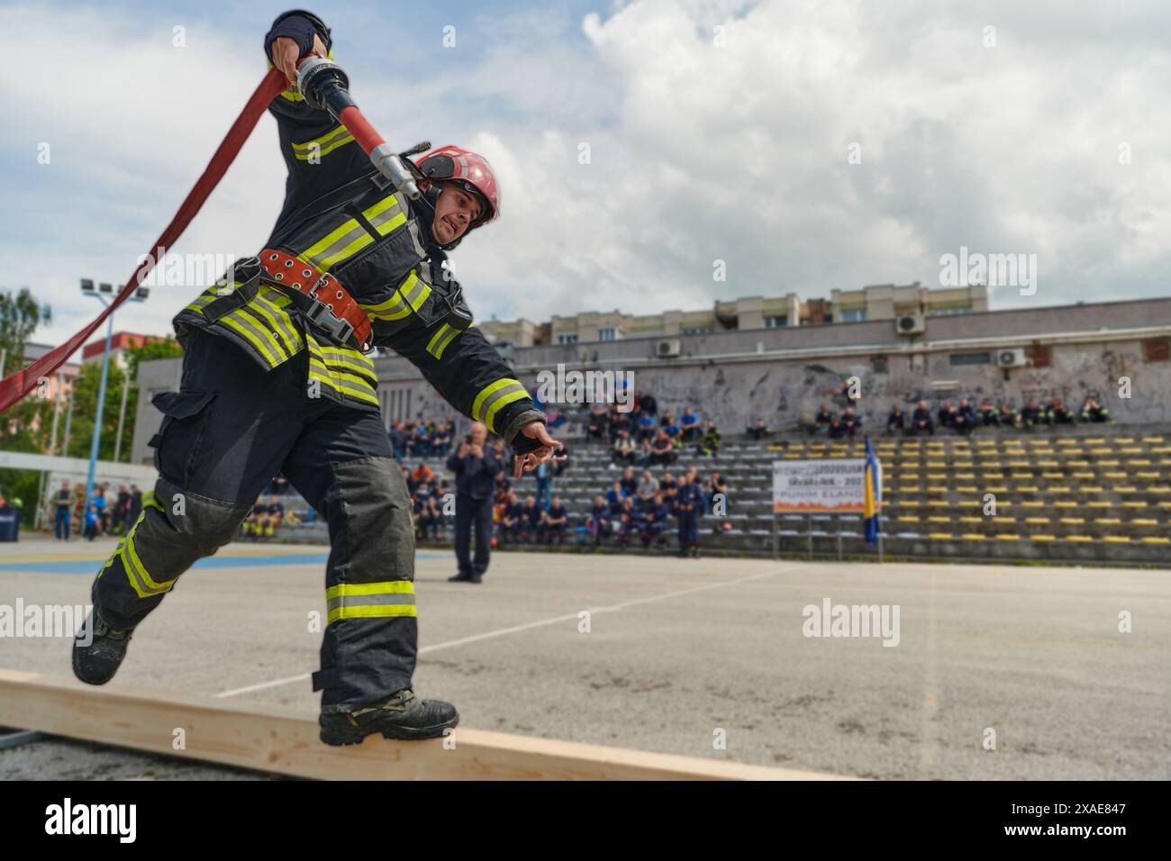 In a dynamic display of synchronized teamwork, firefighters hustle to ...
