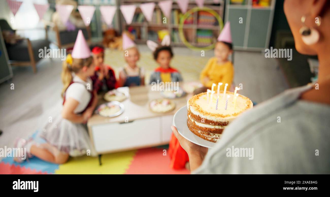 Children, teacher and birthday cake in classroom for school party with ...