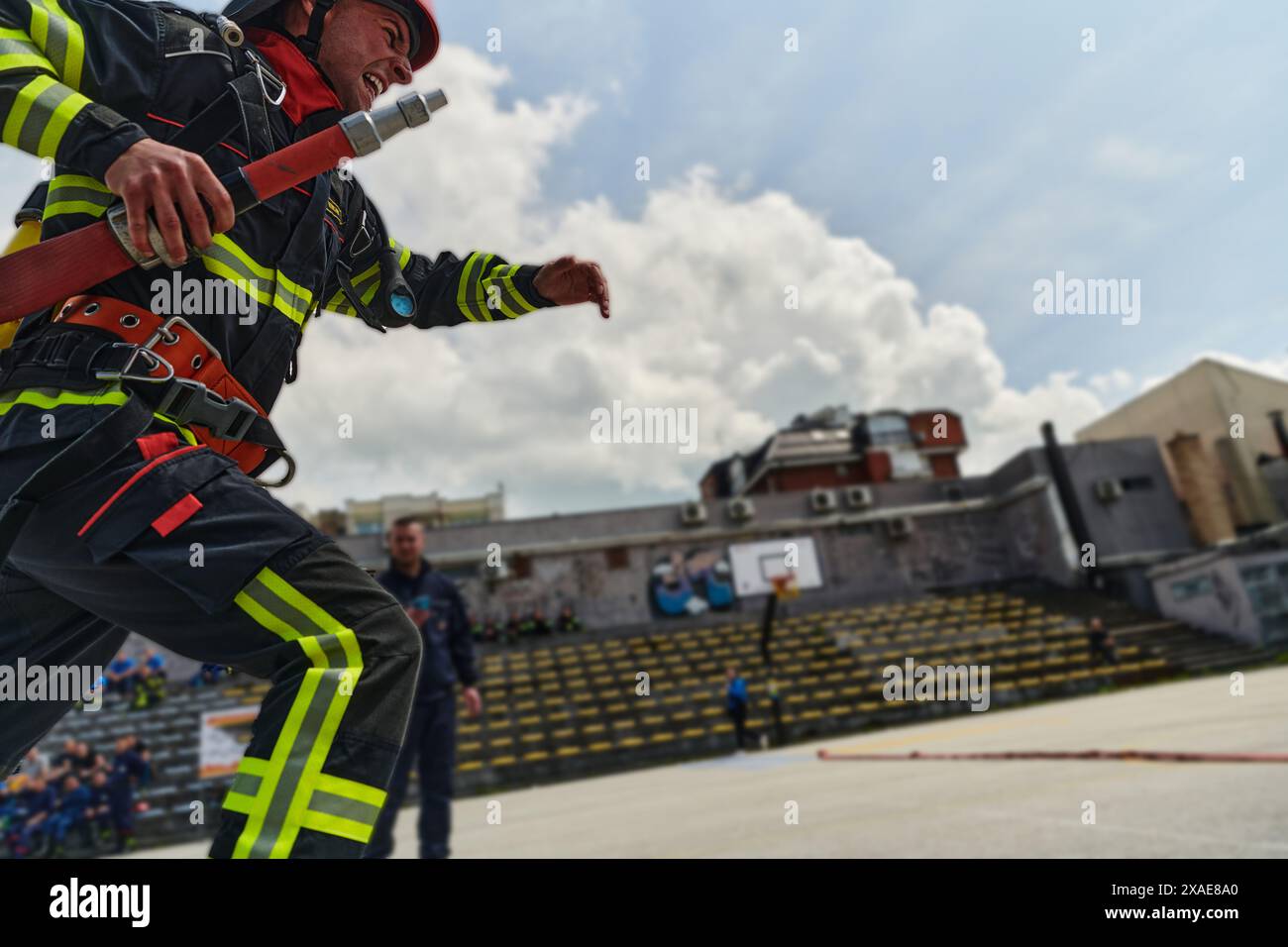 In a dynamic display of synchronized teamwork, firefighters hustle to ...