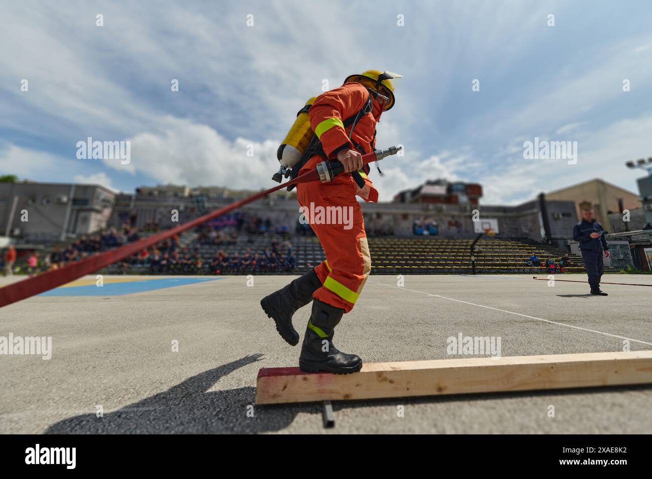 In a dynamic display of synchronized teamwork, firefighters hustle to ...