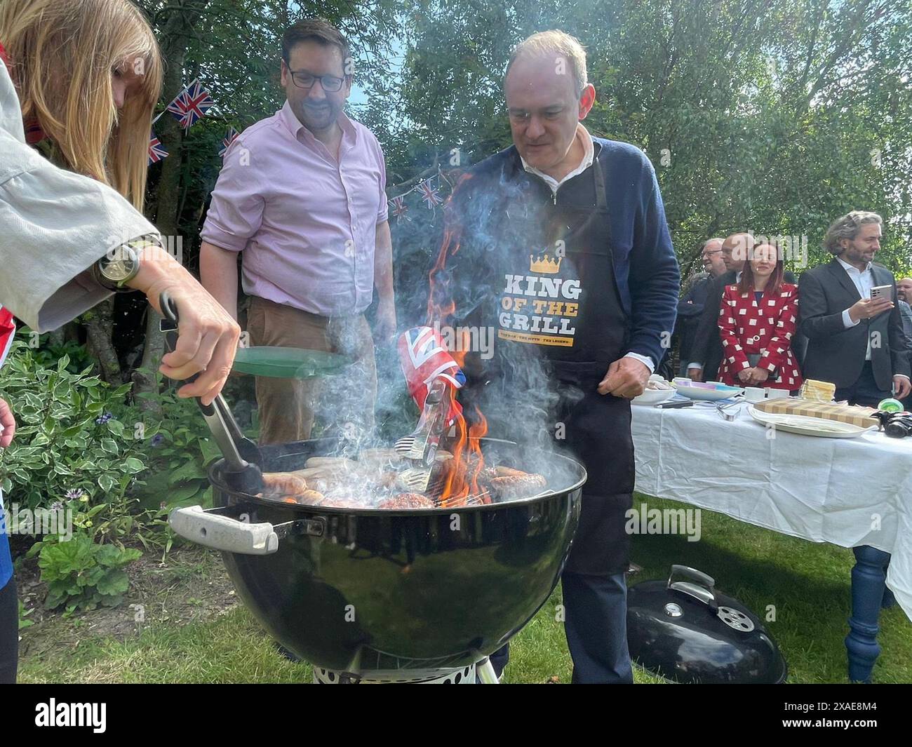 Liberal Democrats leader Sir Ed Davey, flipping burgers in a back ...