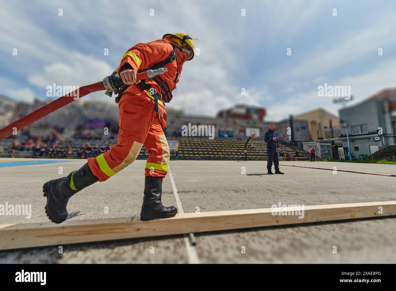 In a dynamic display of synchronized teamwork, firefighters hustle to ...