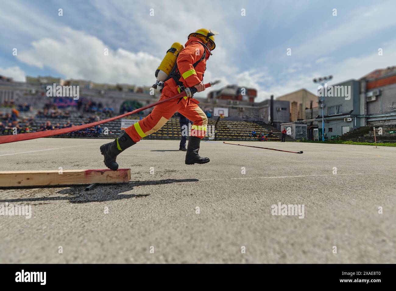 In a dynamic display of synchronized teamwork, firefighters hustle to ...