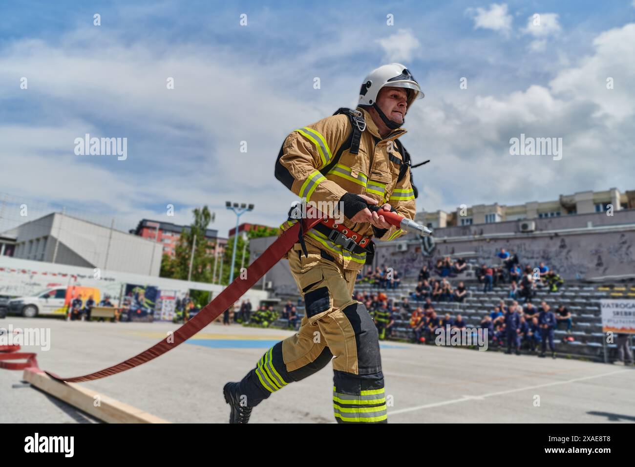 In a dynamic display of synchronized teamwork, firefighters hustle to ...