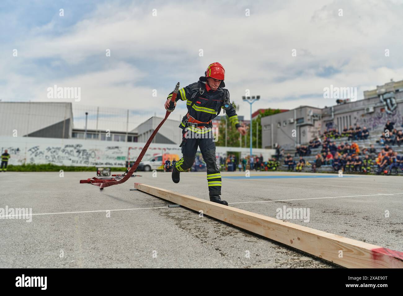 In a dynamic display of synchronized teamwork, firefighters hustle to ...