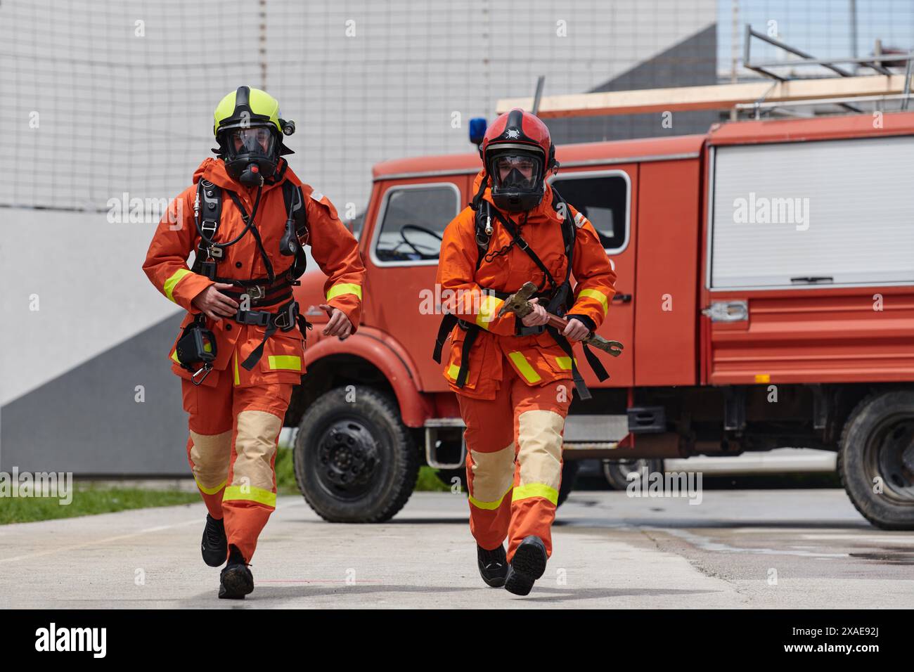 Firefighter Team Training with Various Tools in Professional Gear Stock ...
