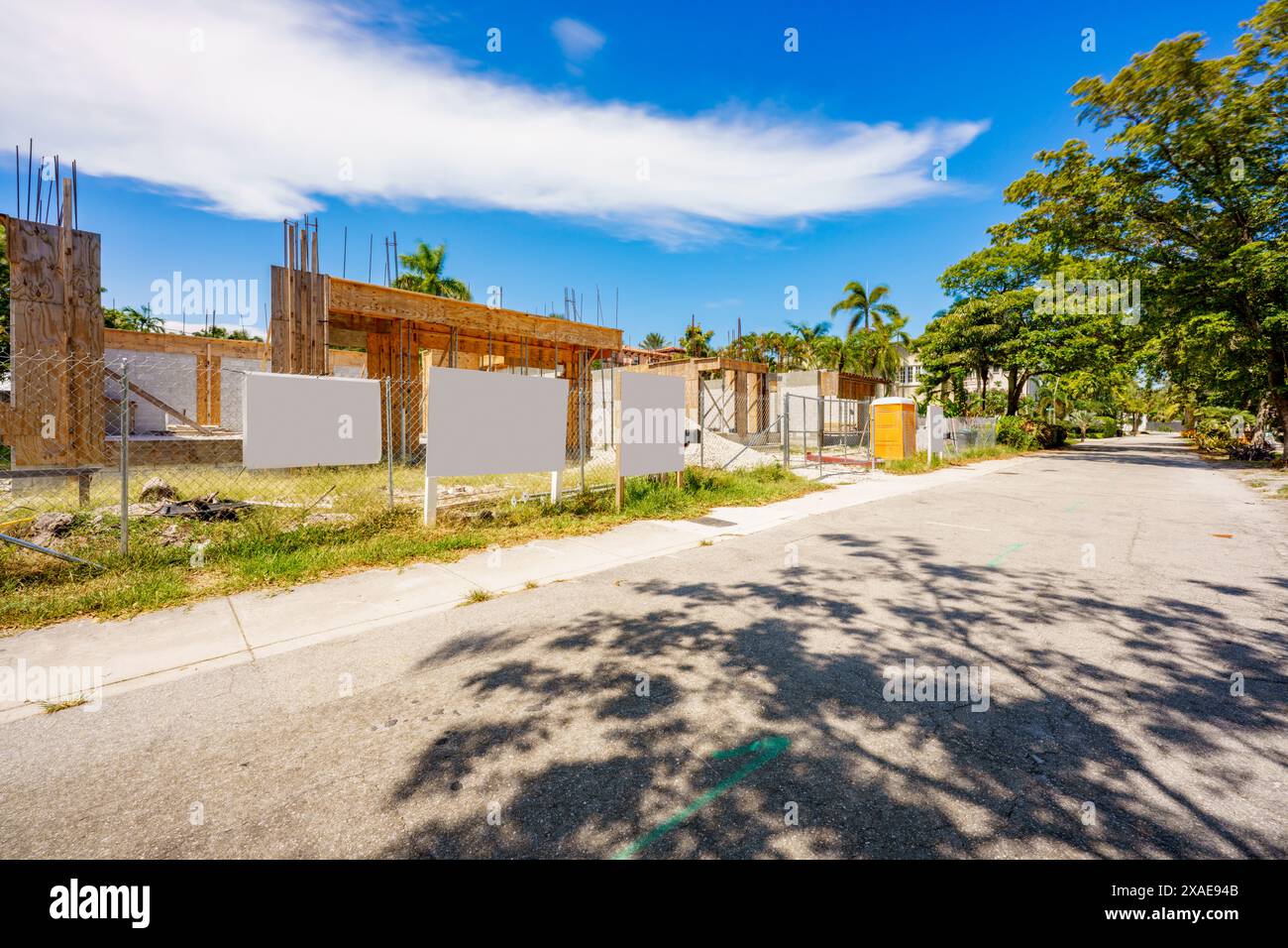 House construction with blank signs and fence. Industrial home ...
