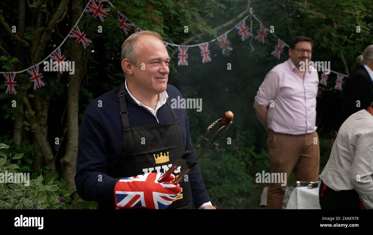 Liberal Democrats leader Sir Ed Davey, cooking sausages and flipping ...