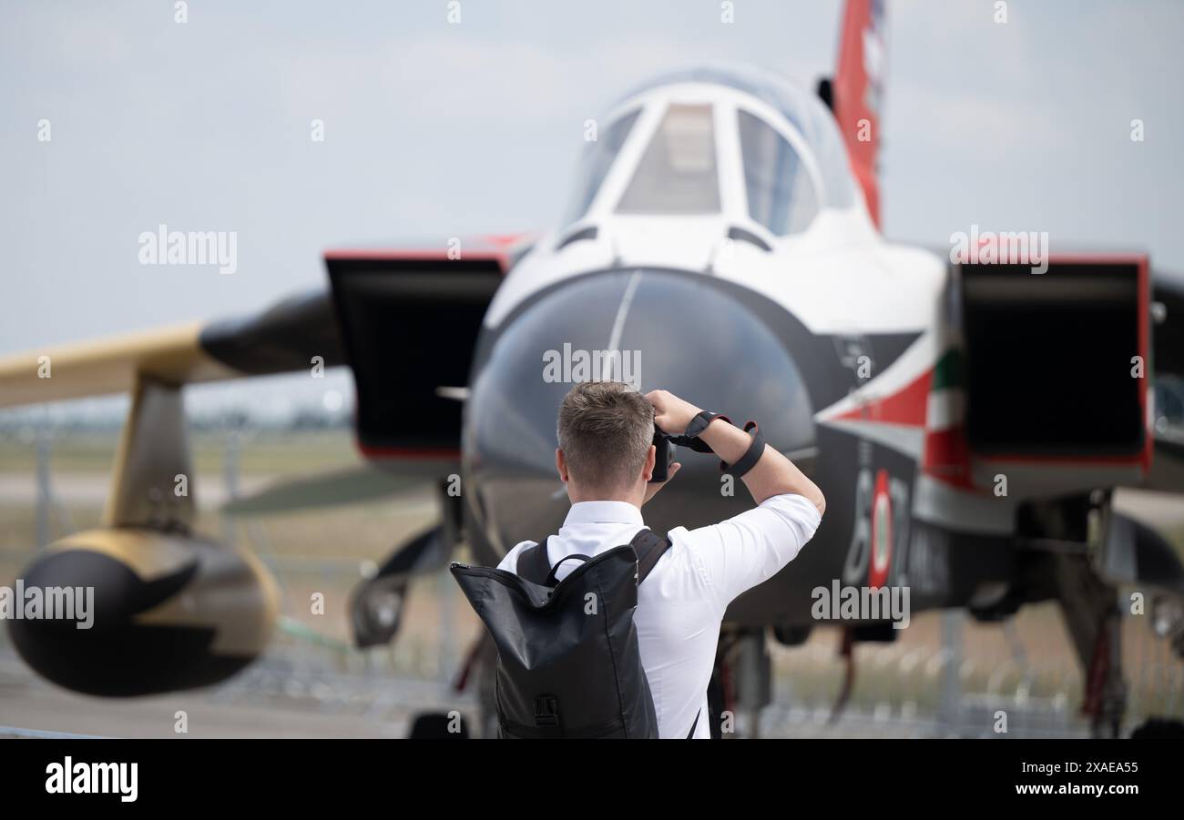 06 June 2024, Brandenburg, Schönefeld: A man photographs a Panavia Tornado during the ...