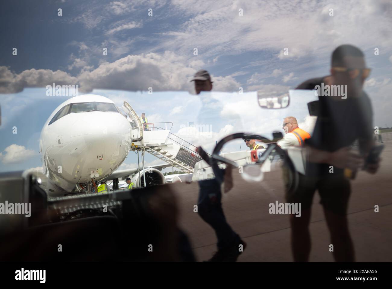 06 June 2024, Brandenburg, Schönefeld: Visitors look through the glass ...