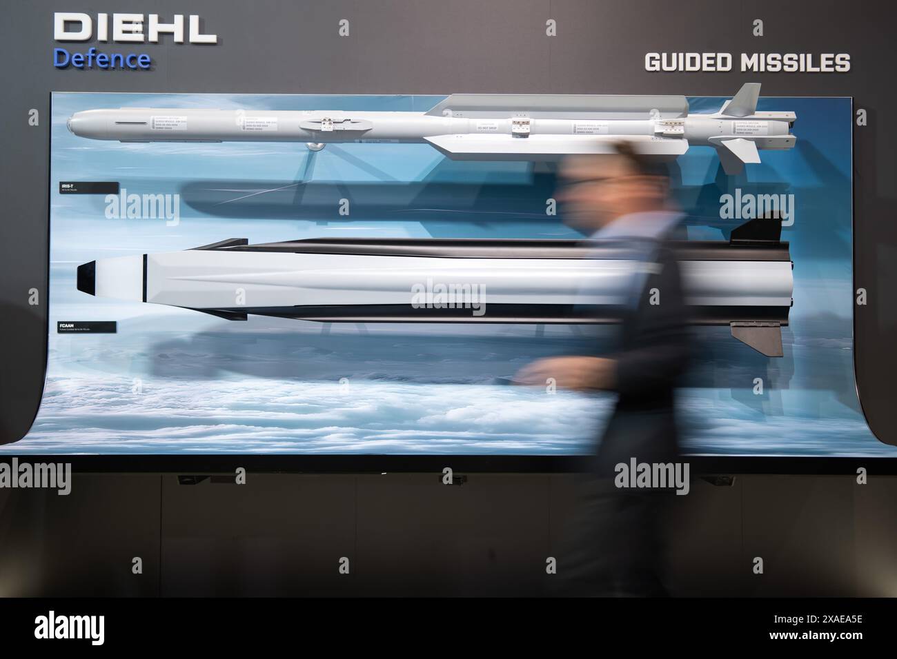 06 June 2024, Brandenburg, Schönefeld: A man walks past a model of an ...