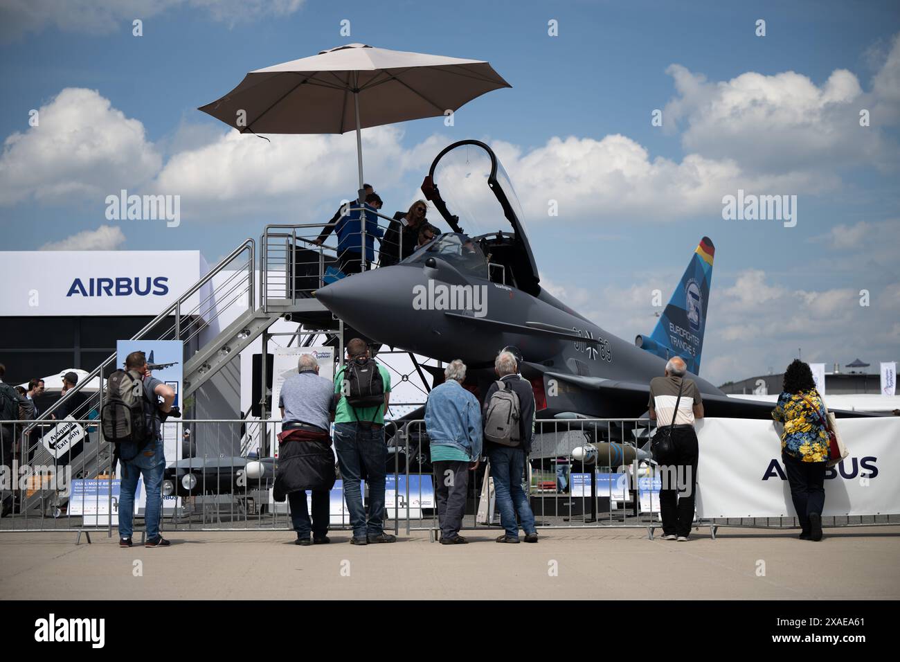 06 June 2024, Brandenburg, Schönefeld: Visitors stand in front of a Eurofighter Typhoon during ...