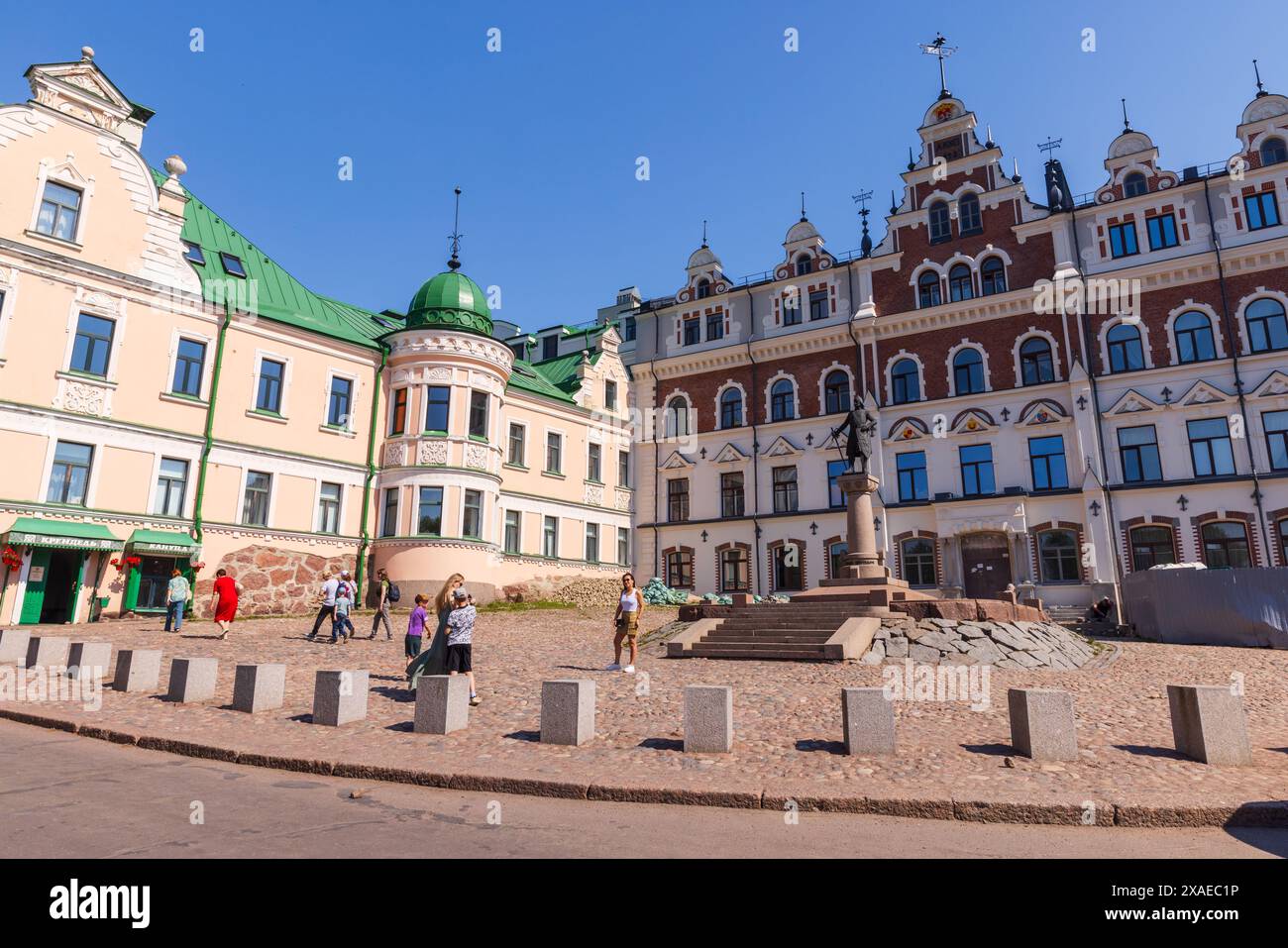 Vyborg, Russia - May 27, 2024: Tourists walk the Old Townhall square in ...