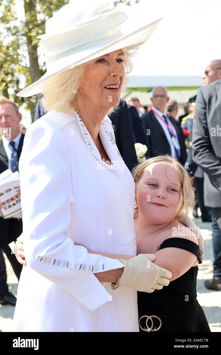 Queen Camilla is hugged by a young well-wisher following the UK ...