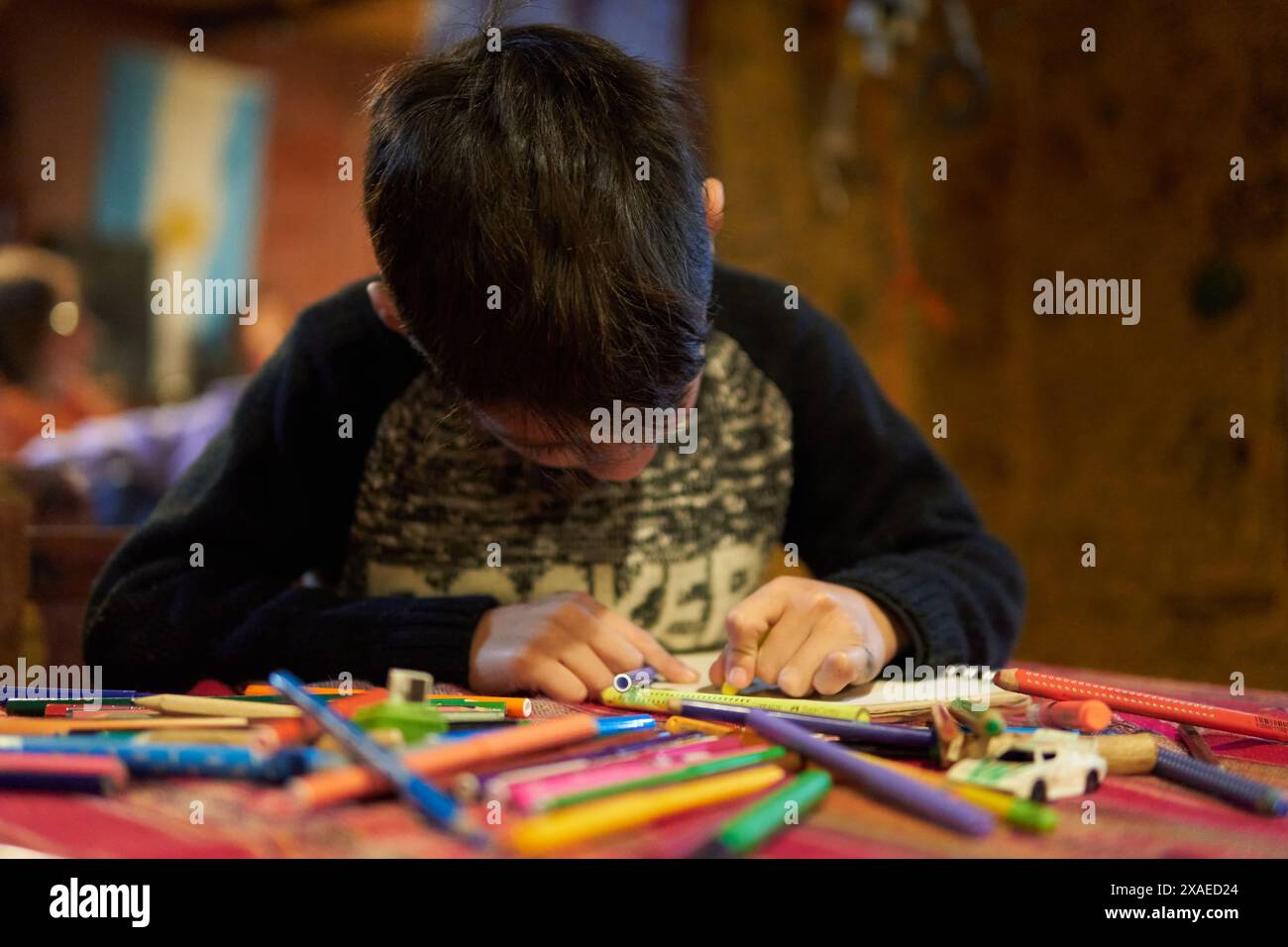 latino boy drawing with crayons in a night bar. Entertainment concept ...