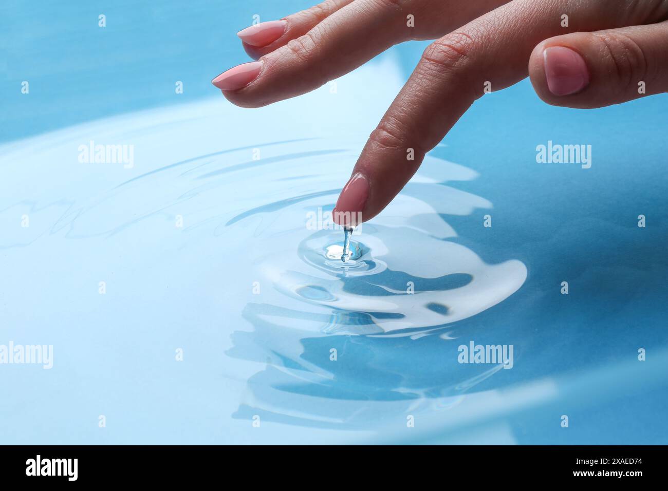 Woman touching clear water, closeup. Making ripples Stock Photo - Alamy