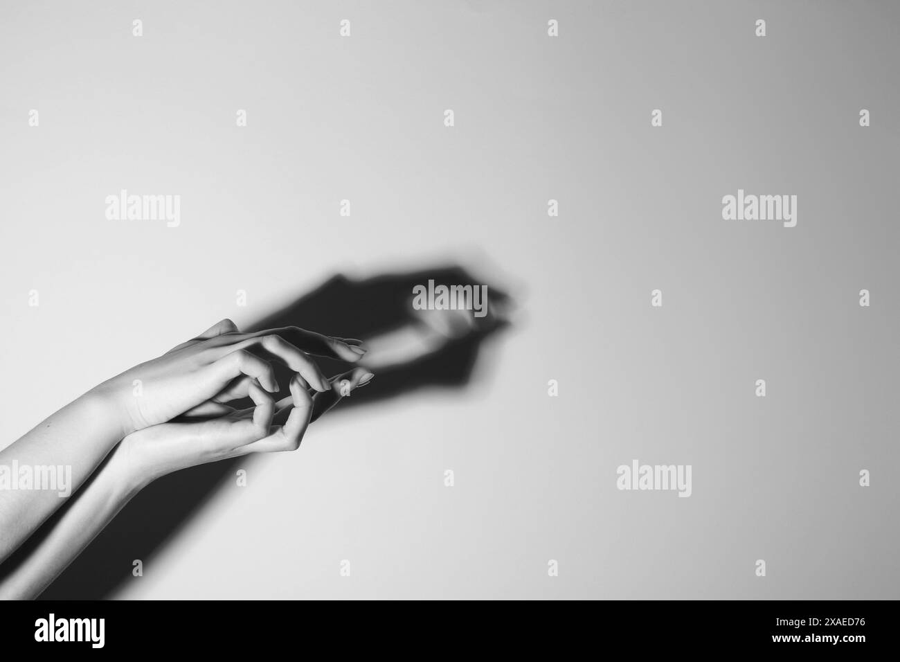 Shadow puppet. Woman making hand gesture like crocodile on light ...