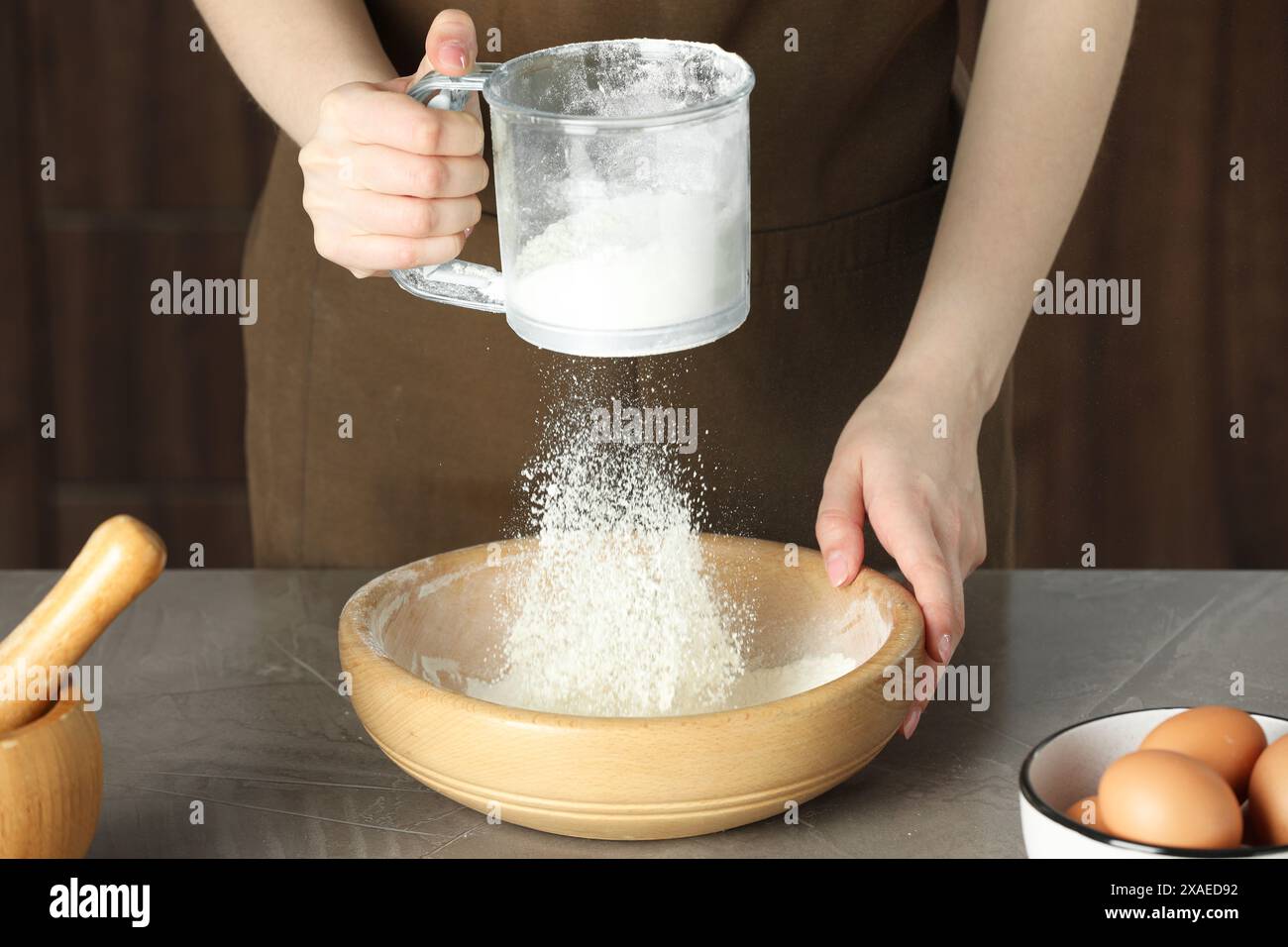 Woman sieving flour grey table hi-res stock photography and images - Alamy