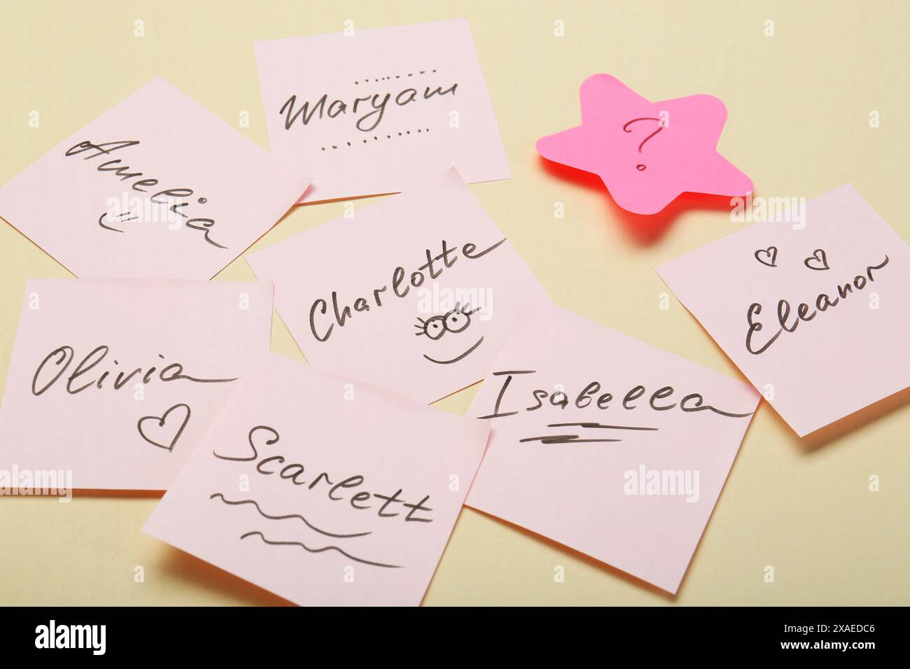 Choosing baby name. Paper stickers with different names and question ...