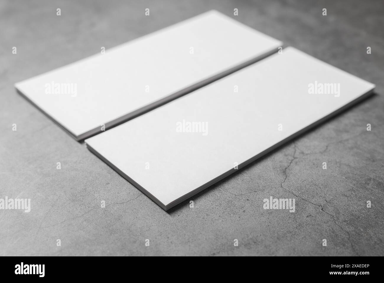 Blank business cards on grey textured table, closeup. Mockup for design ...