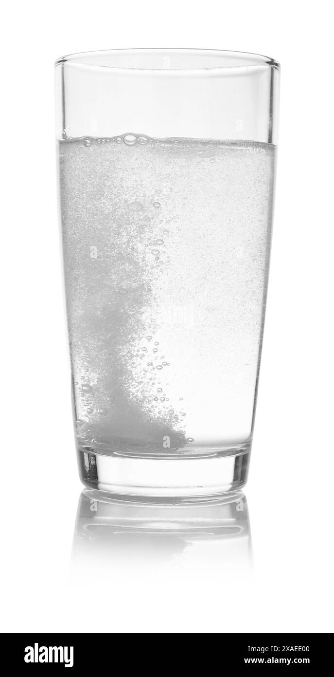 Effervescent pill dissolving in glass of water isolated on white Stock ...