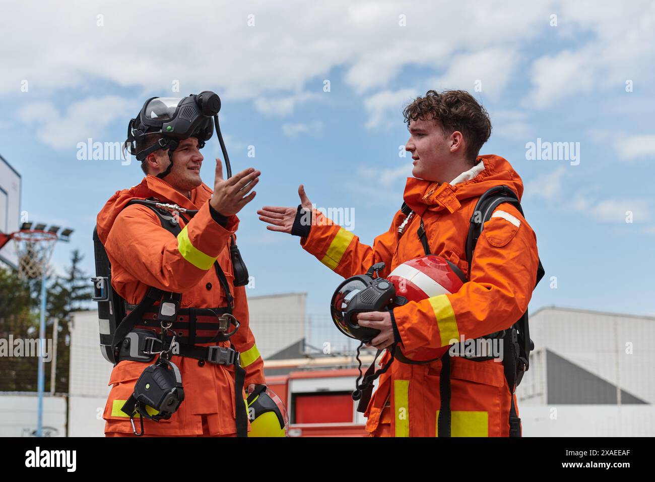 A unified team of firefighters, adorned in their uniforms, engages in a ...