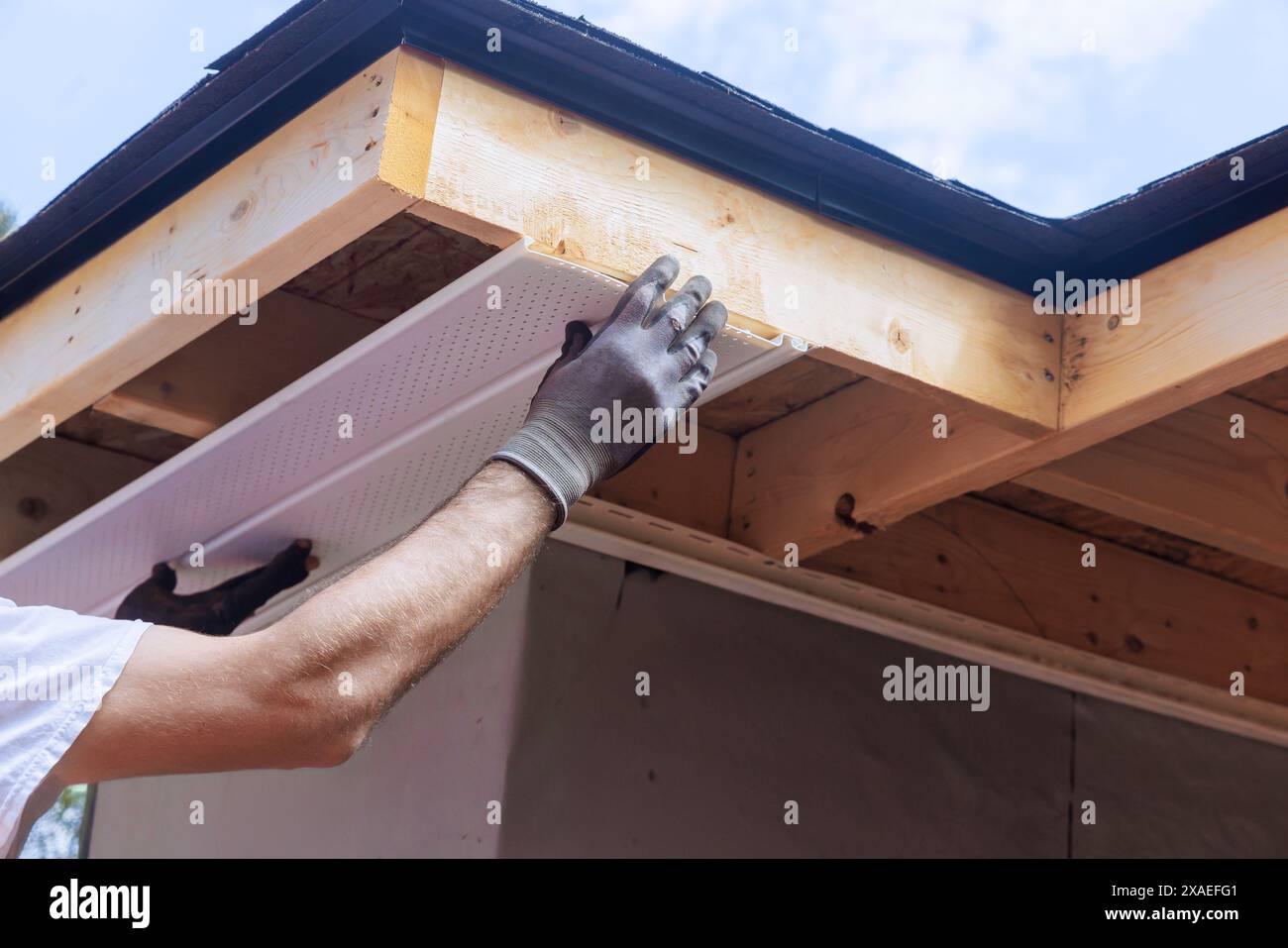 An installation of upvc soffit board at corner of roof rafters ceiling ...