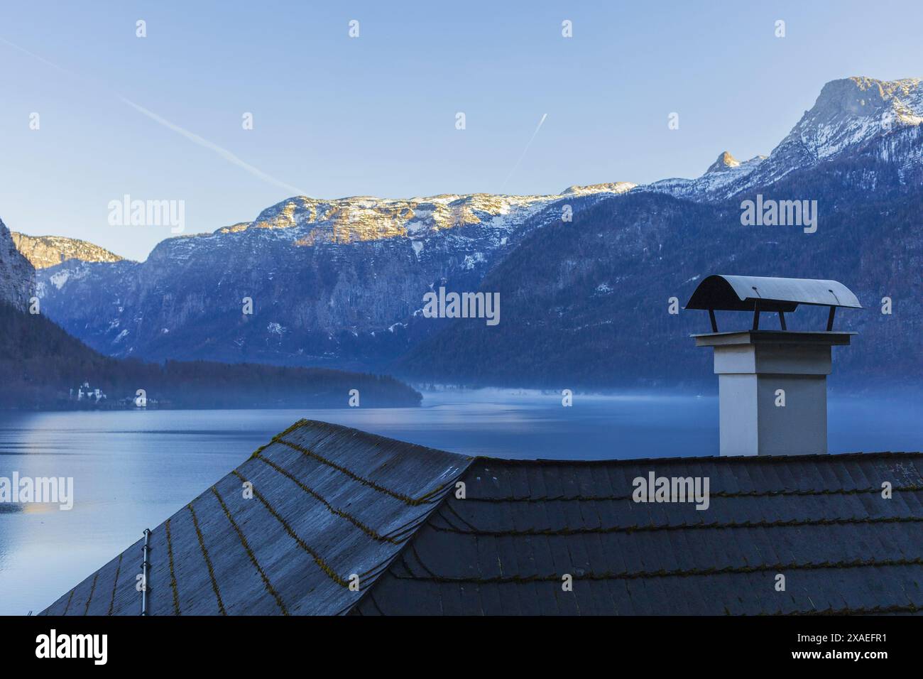photography of the Alpine mountain above house roof with chimney on ...