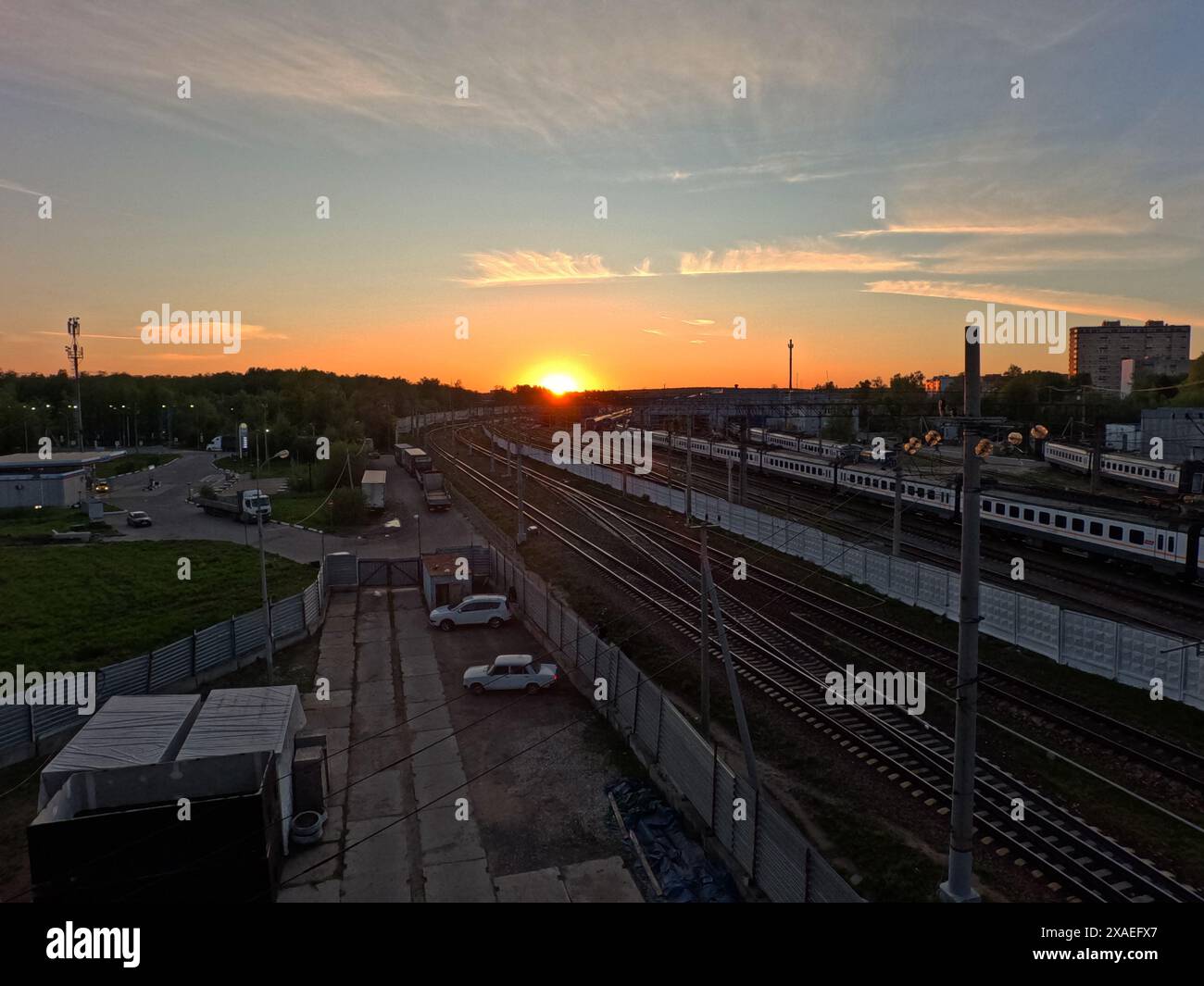 Sunset against the background of railway infrastructure solutions ...