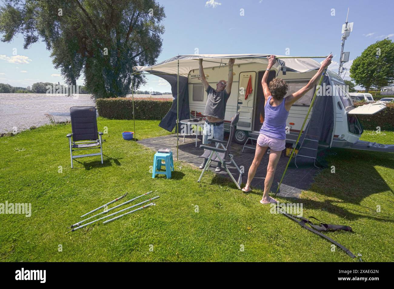 Netherlands, Slijk-Ewijk, 5-6-2024 Camping guests pack their caravan at ...