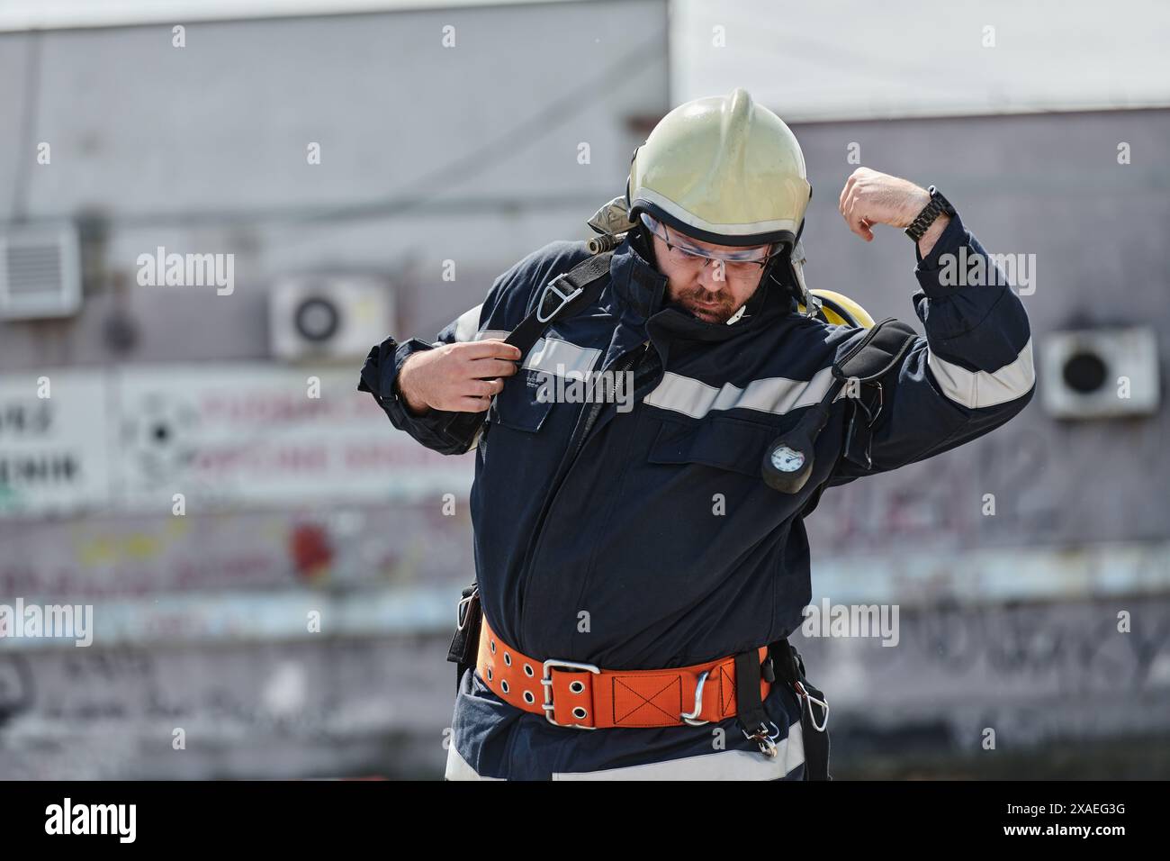 A firefighter dons the essential components of their professional gear ...